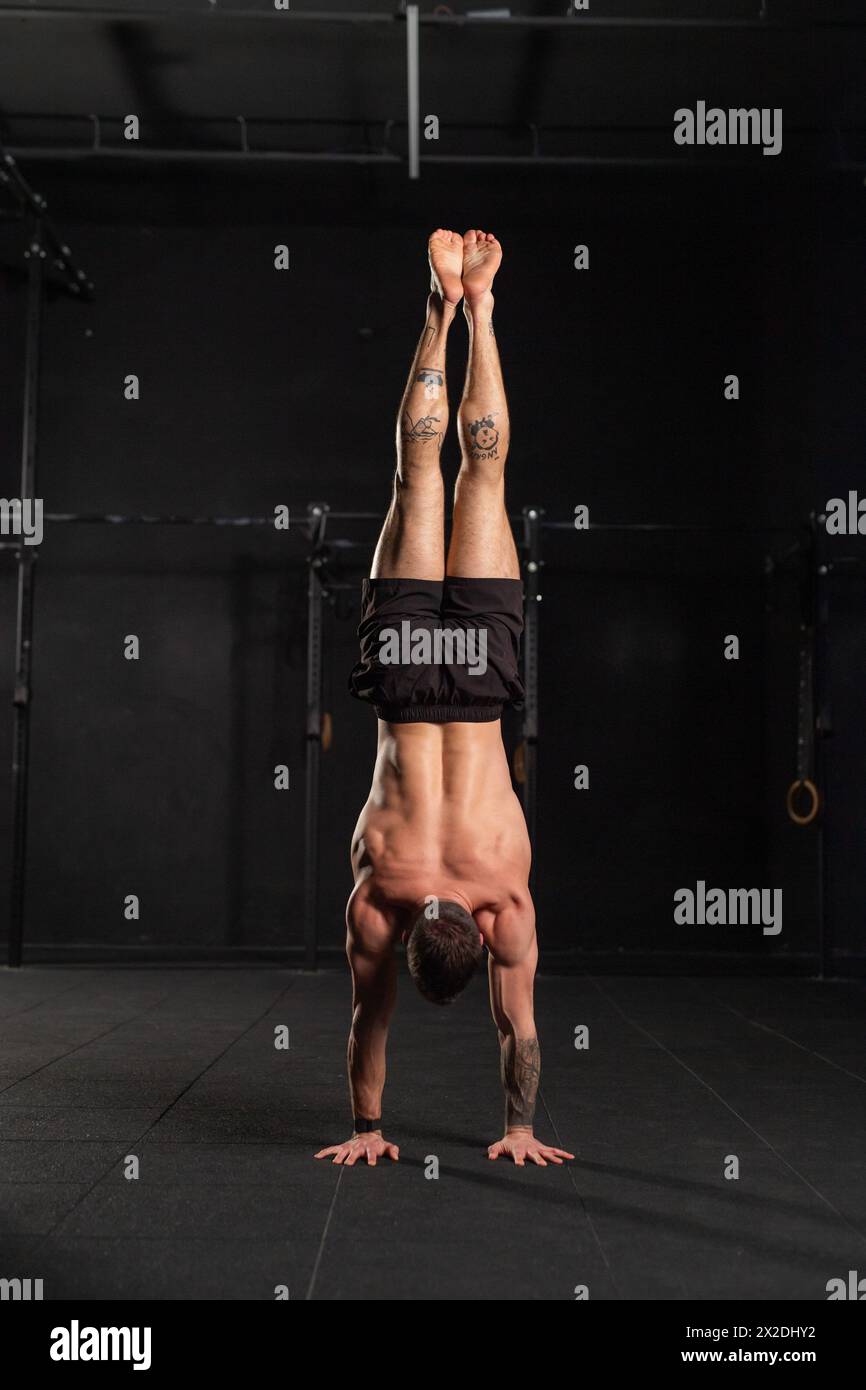 Rear view of handstand exercise, handstand push-ups. Routine workout ...