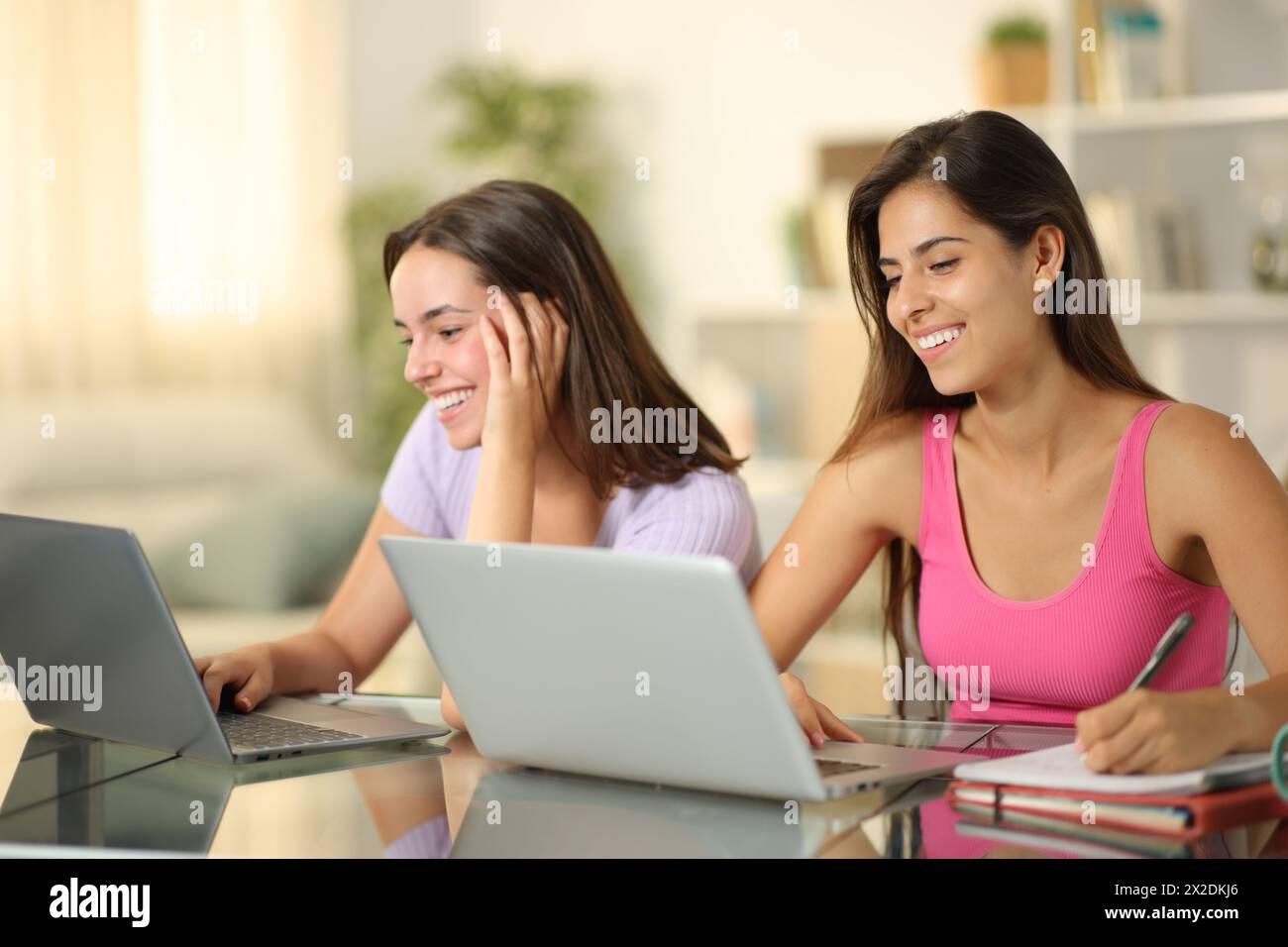 Happy students learning online with laptops at home Stock Photo - Alamy