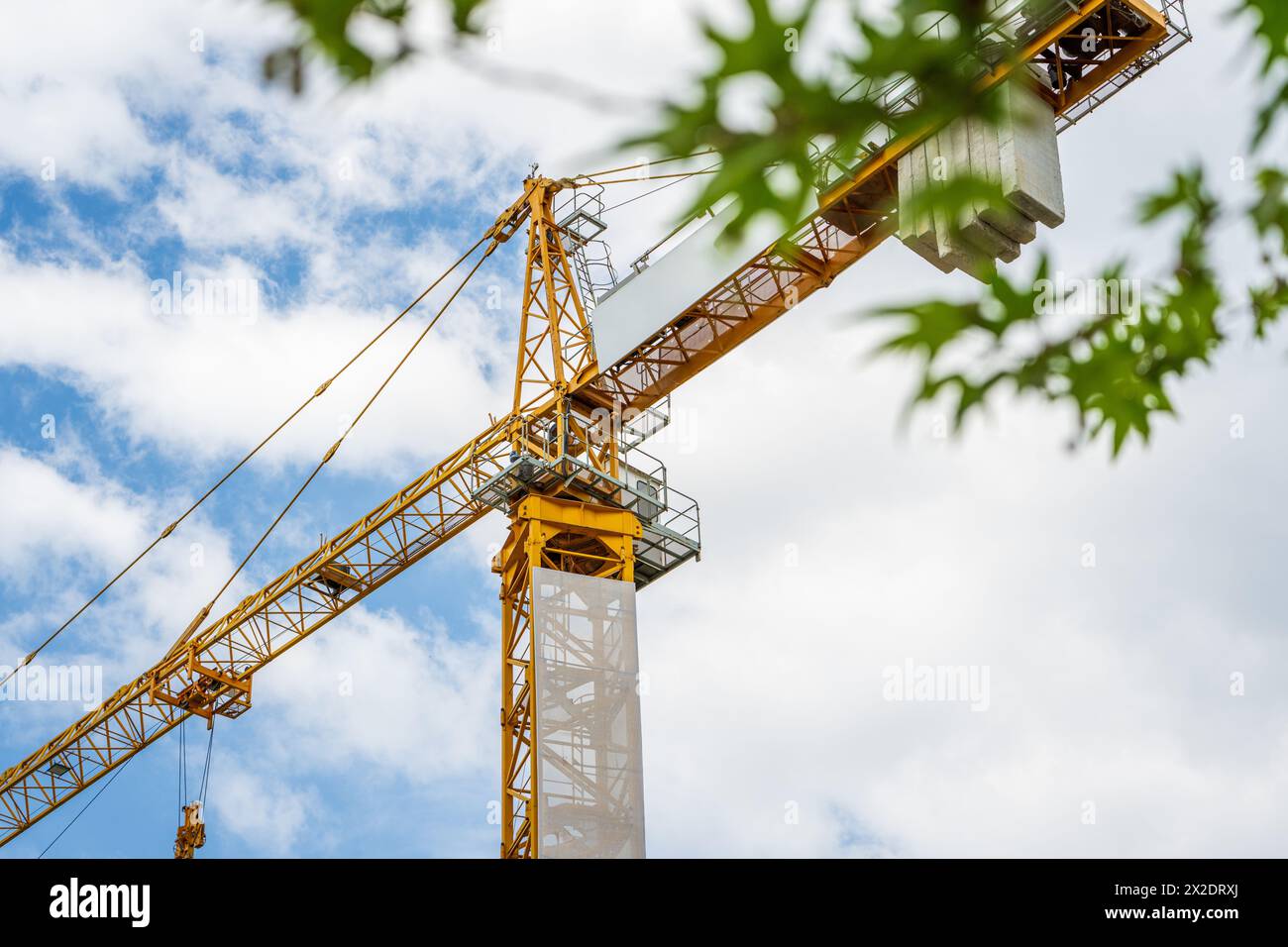 Construction crane working on large construction site Stock Photo - Alamy