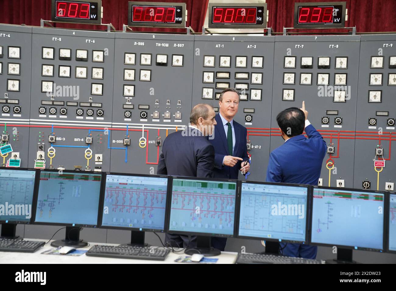 Foreign Secretary Lord David Cameron (centre) in the control room of ...