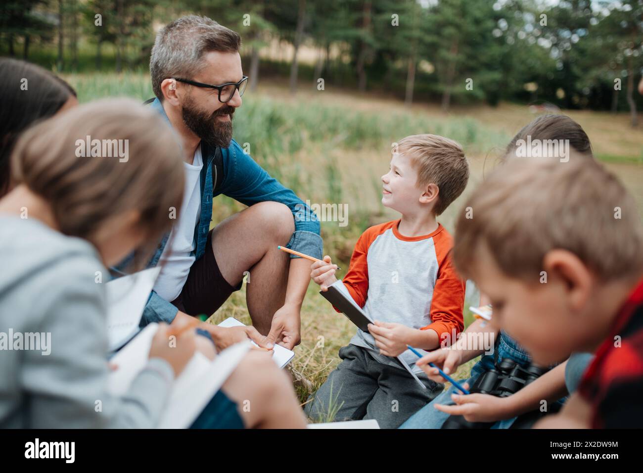 Young students learning about nature, forest ecosystem during biology ...