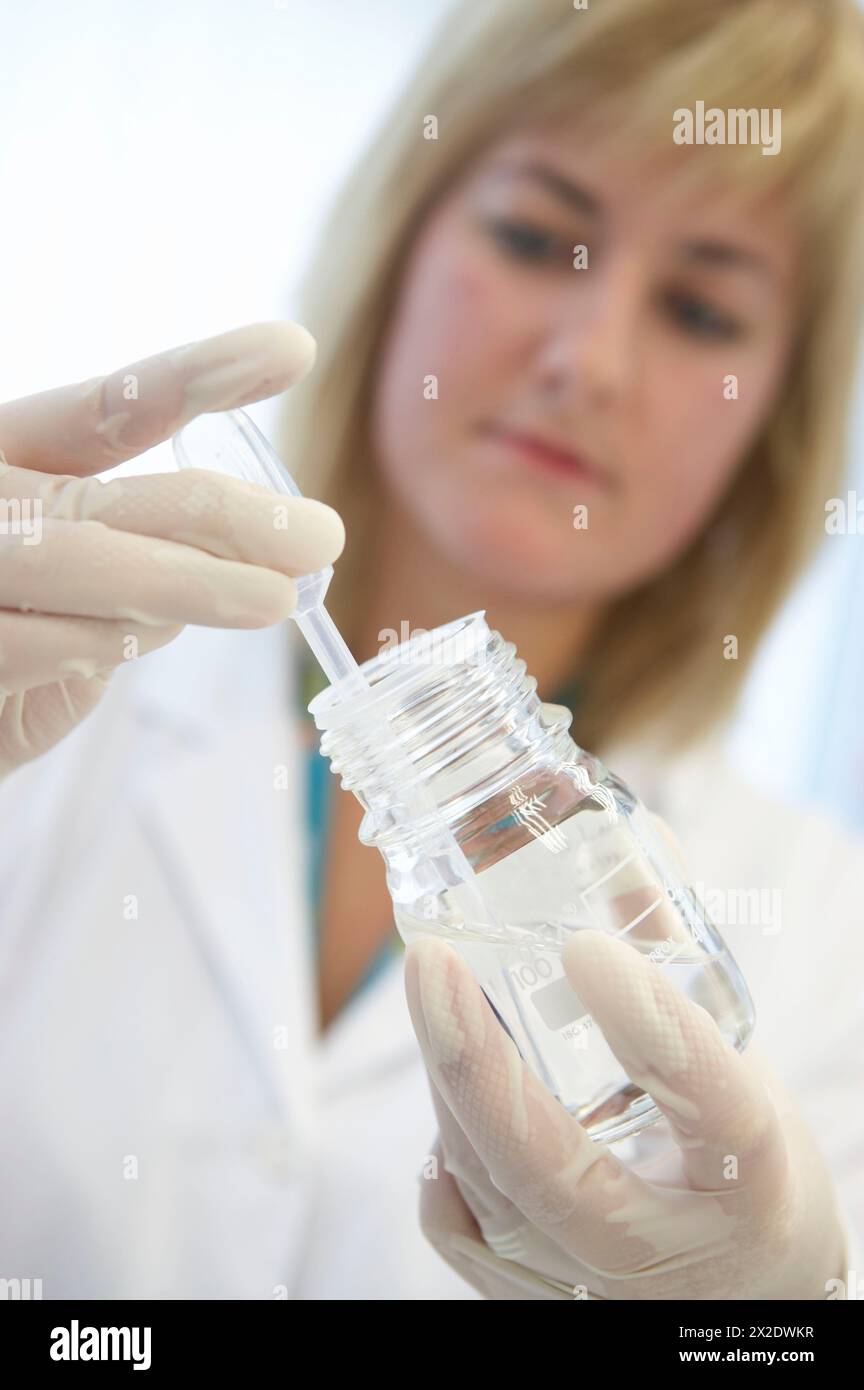 Technical staff taking samples of chemical solution. Laboratory ...