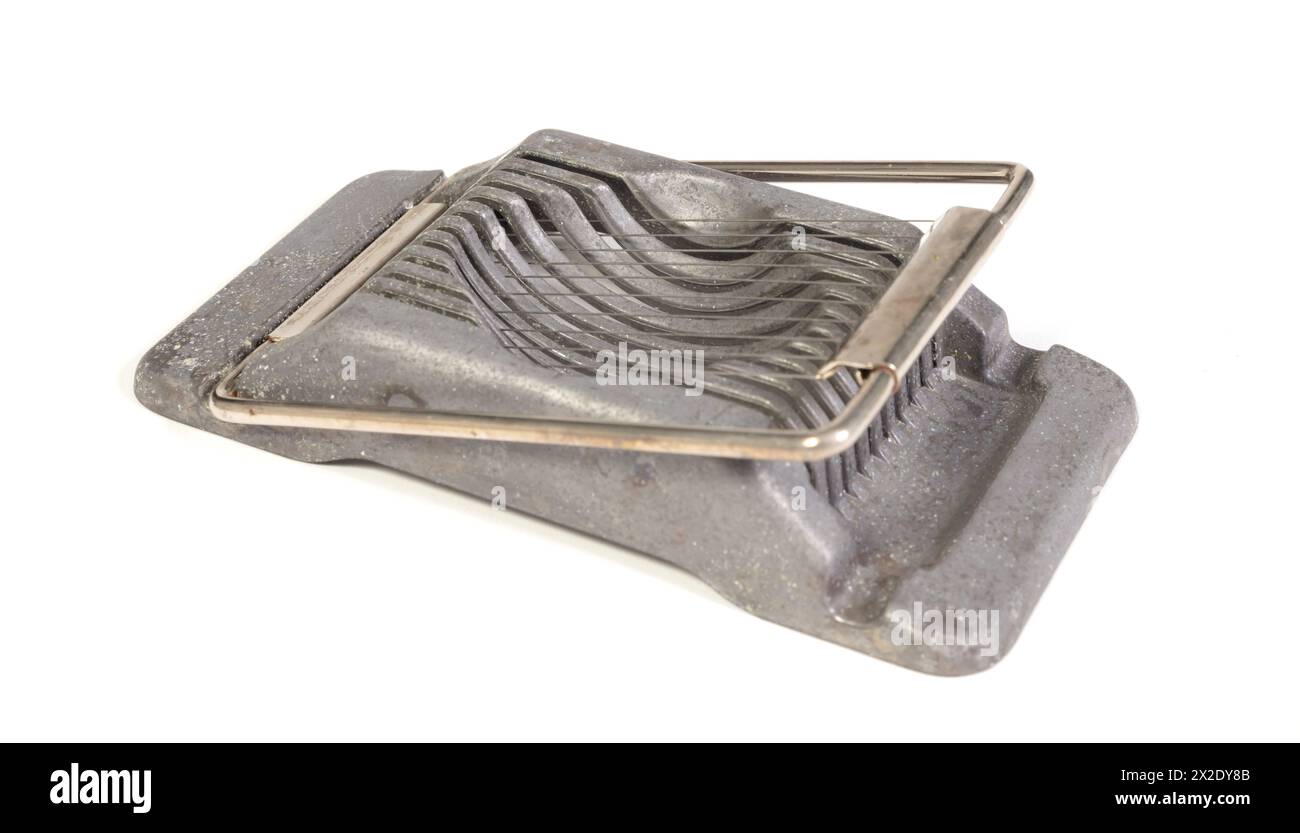 Very old egg cutter isolated on a solid background Stock Photo - Alamy