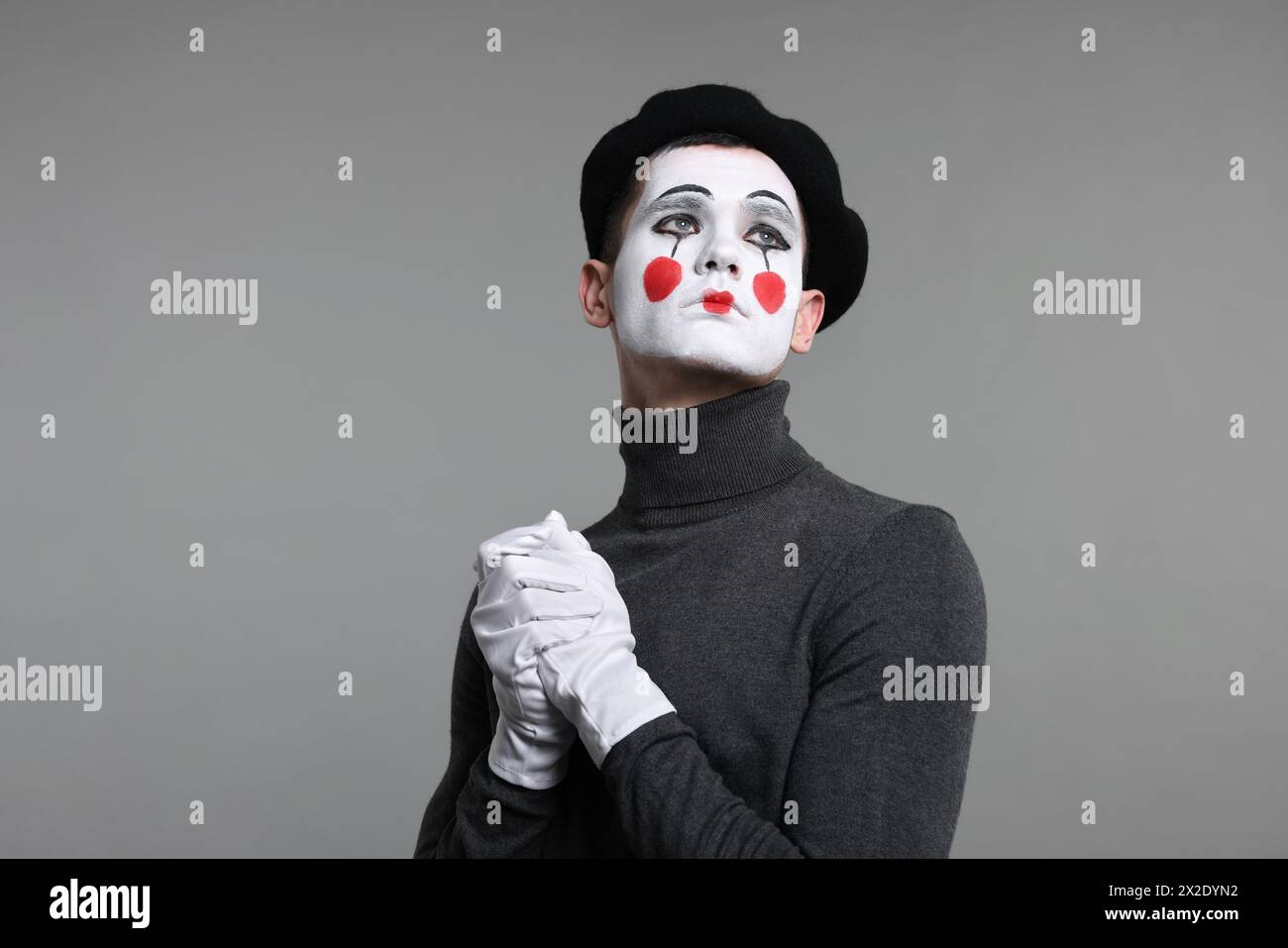 Portrait of mime artist in beret on grey background Stock Photo - Alamy