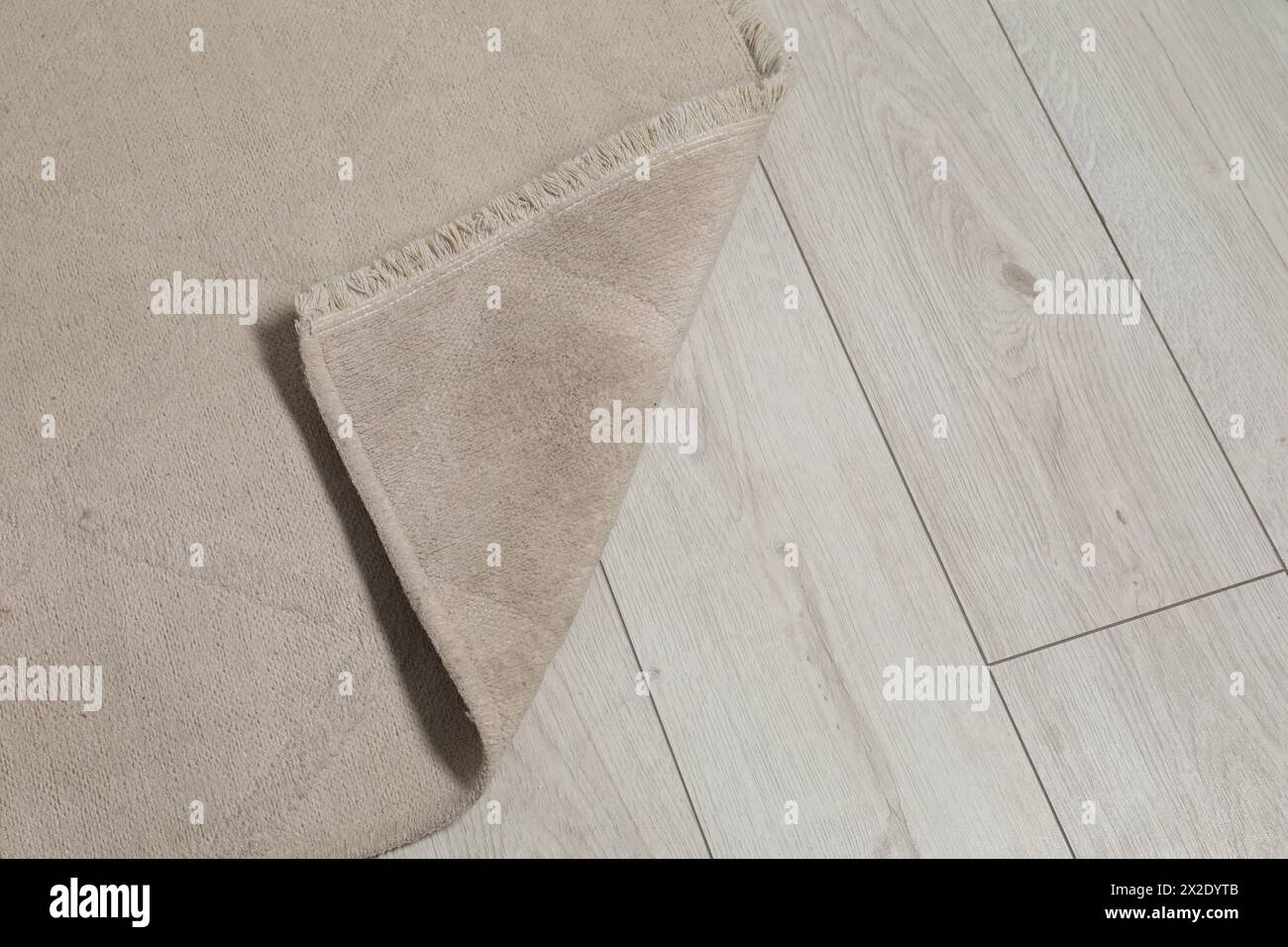 Soft beige carpet on white laminated floor indoors, top view. Space for ...