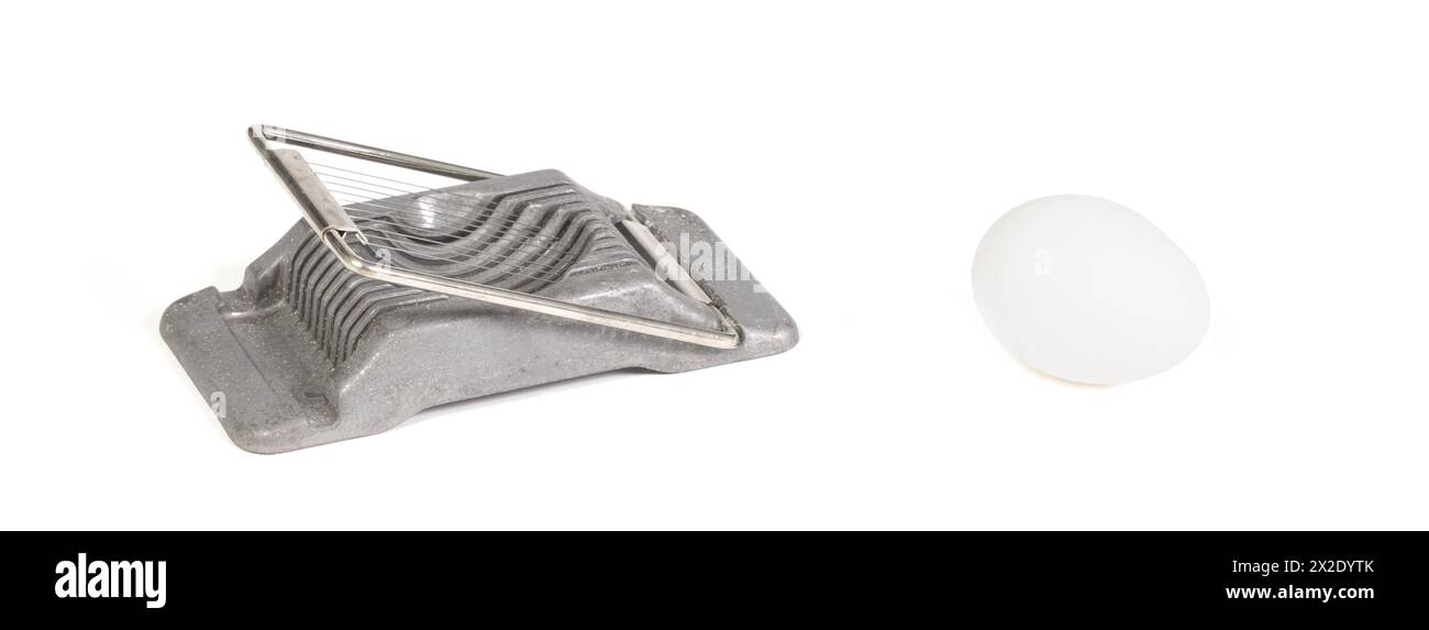 Very old egg cutter isolated on a solid background Stock Photo - Alamy