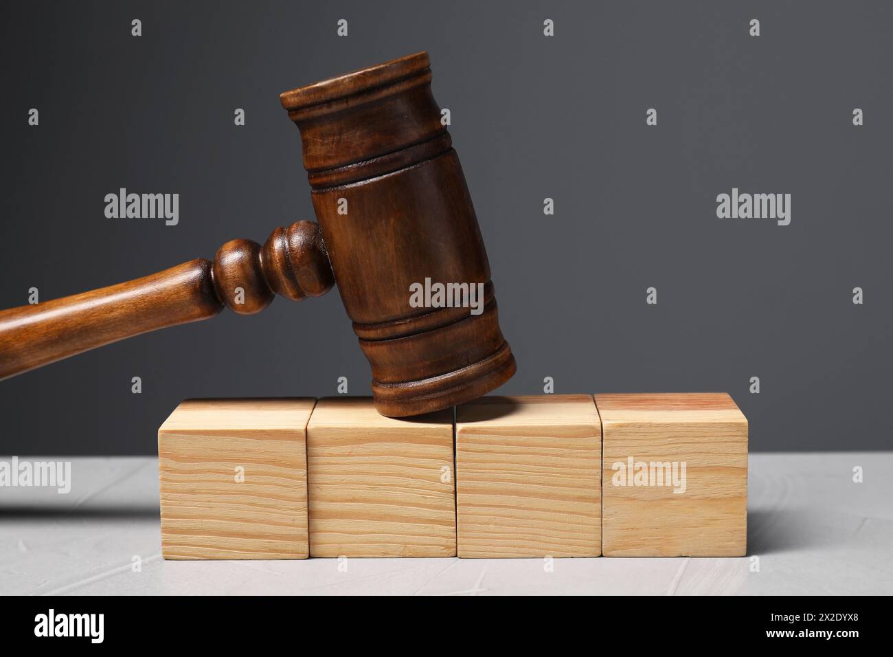 Law. Blank wooden cubes and gavel on light table against gray ...