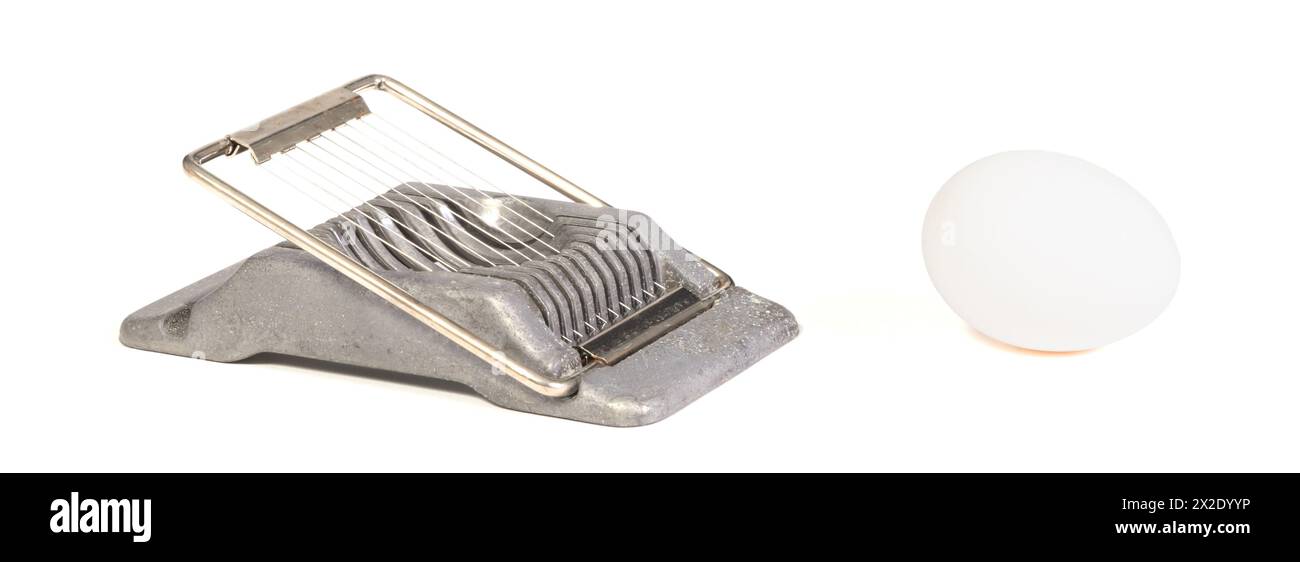 Very old egg cutter isolated on a solid background Stock Photo - Alamy
