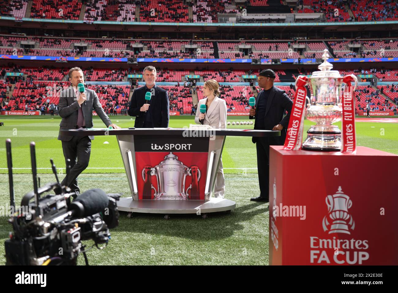 London, UK. 21st Apr, 2024. The FA Cup Trophy with ITV presenters Mark ...