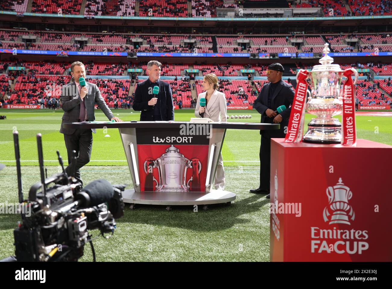 London, UK. 21st Apr, 2024. The FA Cup Trophy with ITV presenters Mark ...