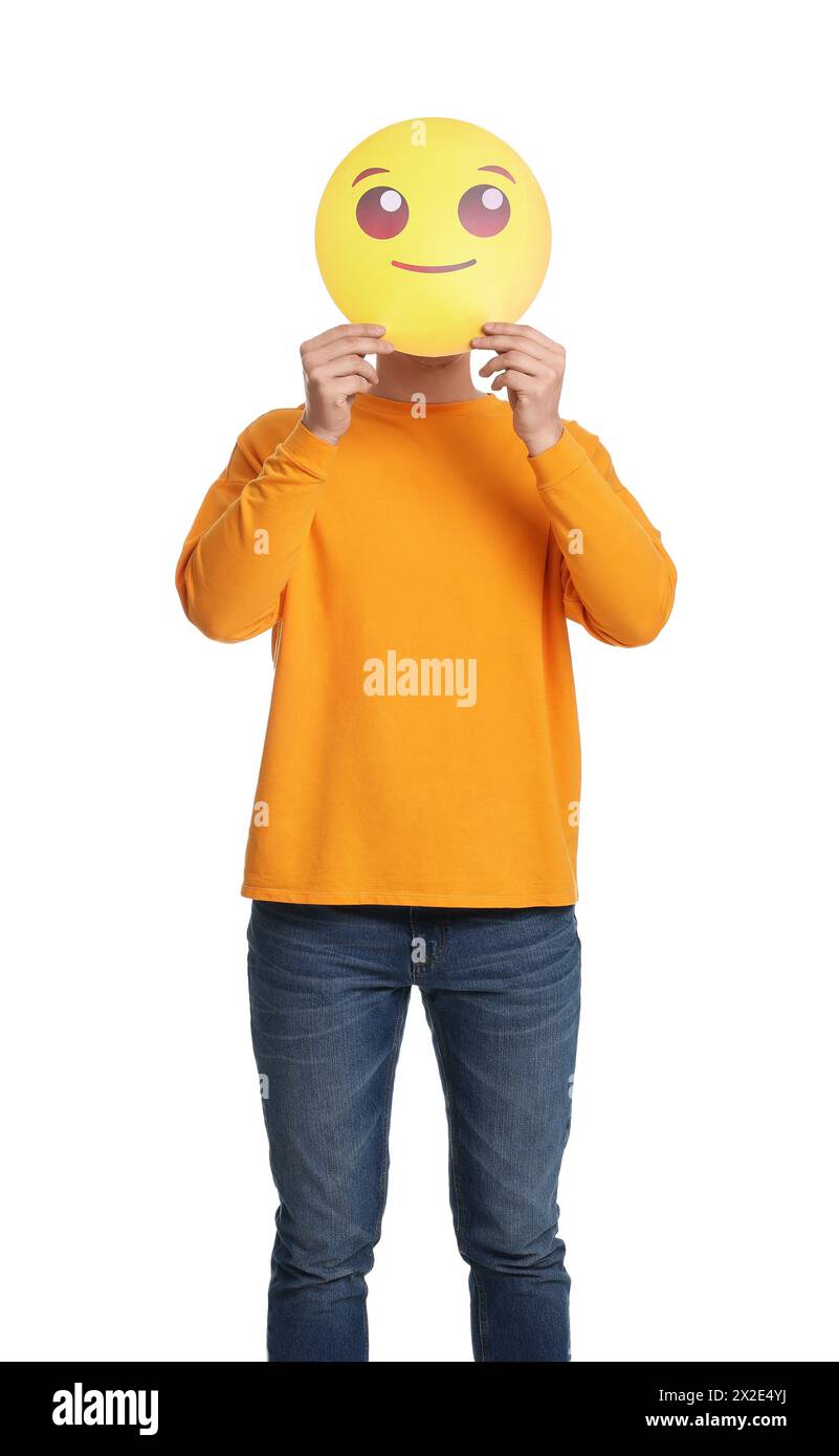 Man covering face with smiling emoticon on white background Stock Photo ...