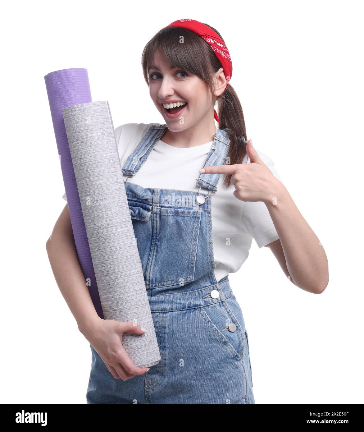 Beautiful woman pointing at wallpaper rolls on white background Stock ...