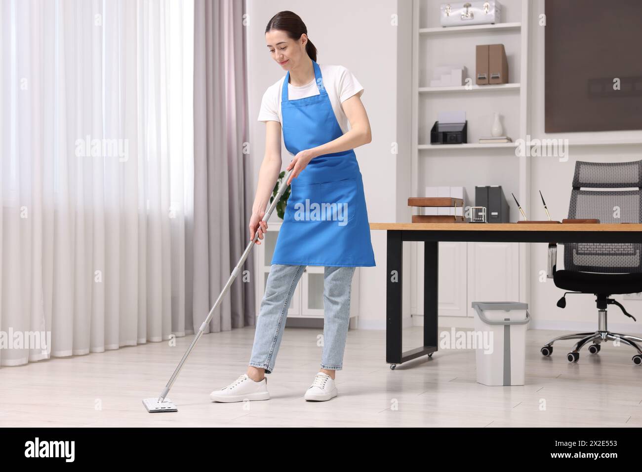 Cleaning service. Woman washing floor with mop in office Stock Photo ...