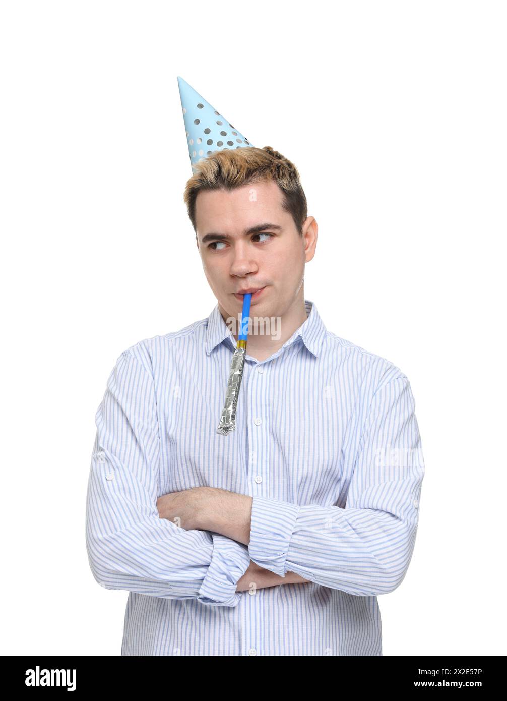 Sad young man with party hat and blower on white background Stock Photo ...