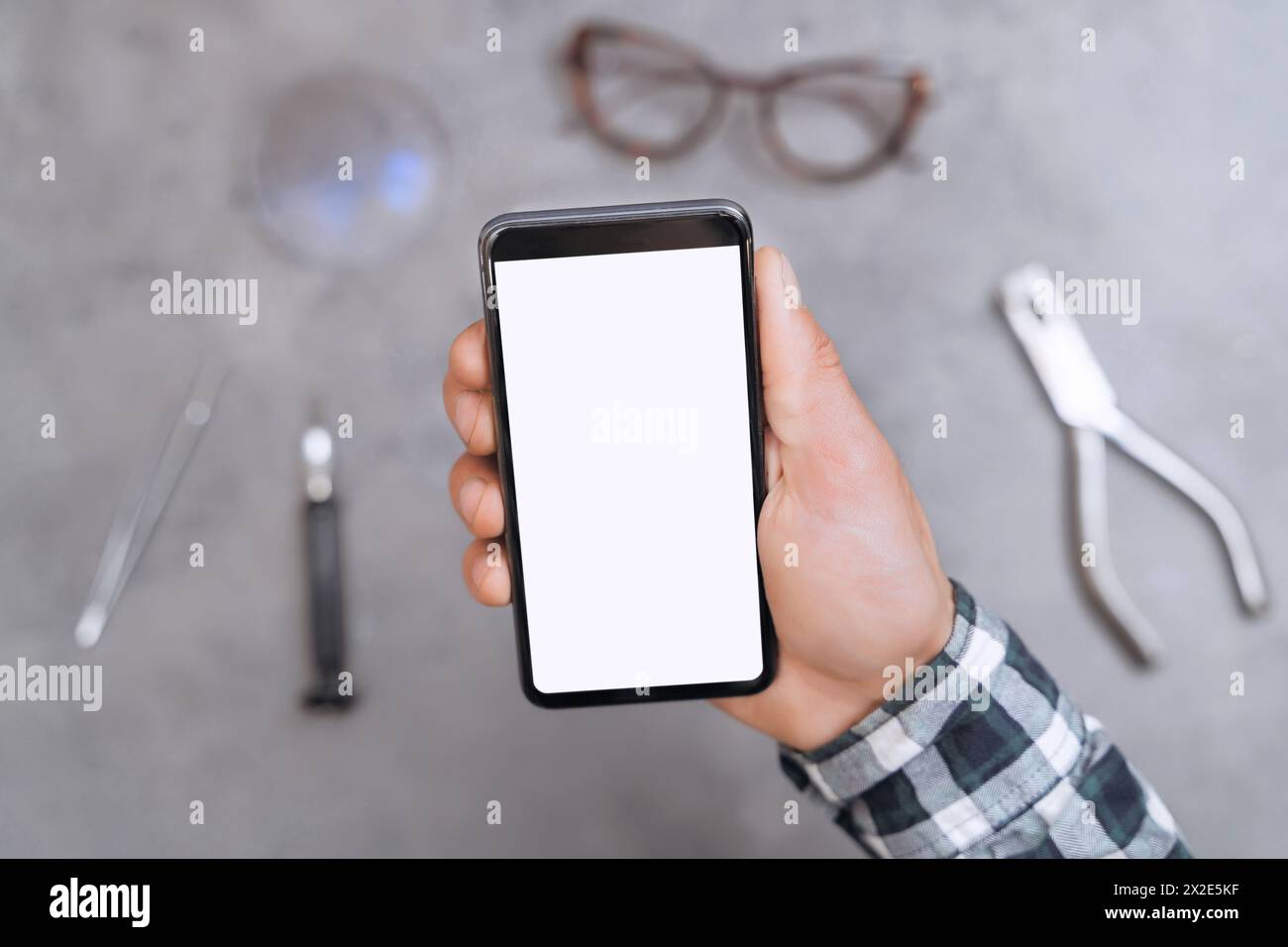 Smartphone with blank screen for text, location, advertisement in hand ...