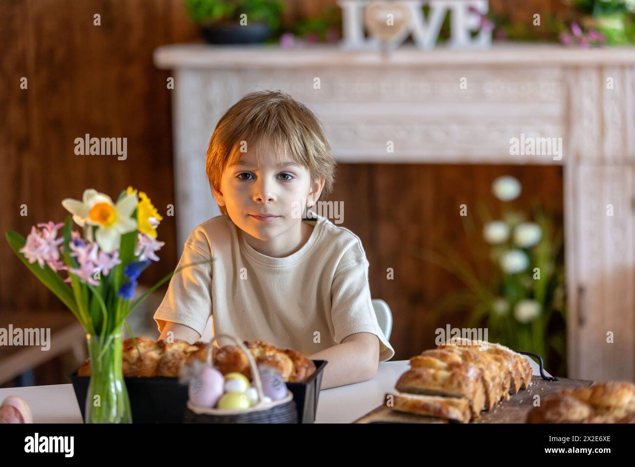 Cute preschool child, boy, holding sweet brioche bun for Easter ...
