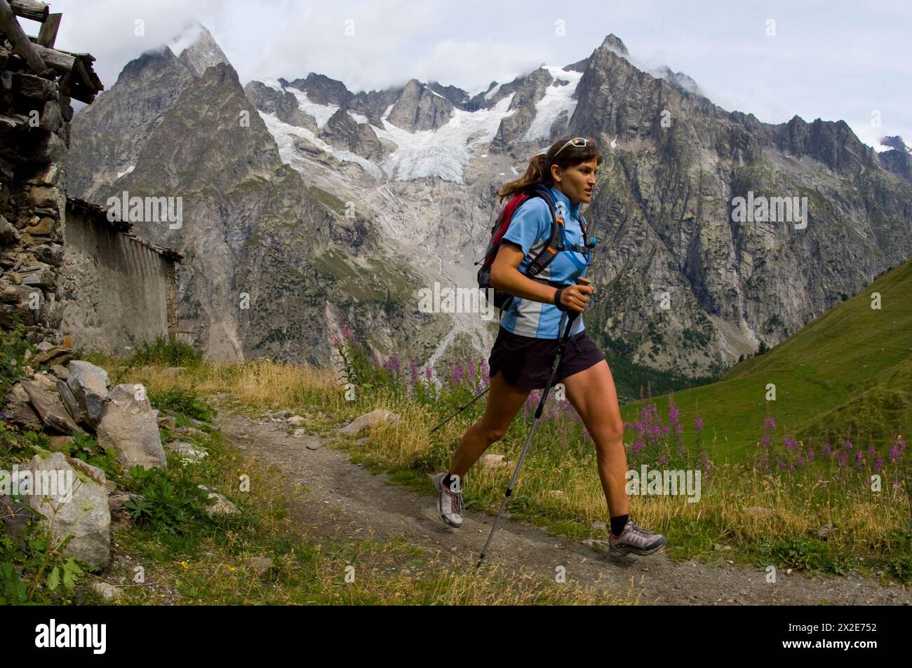 Woman hiking on the Tour Du Mt Blanc (TMB) trail on the italian side of ...
