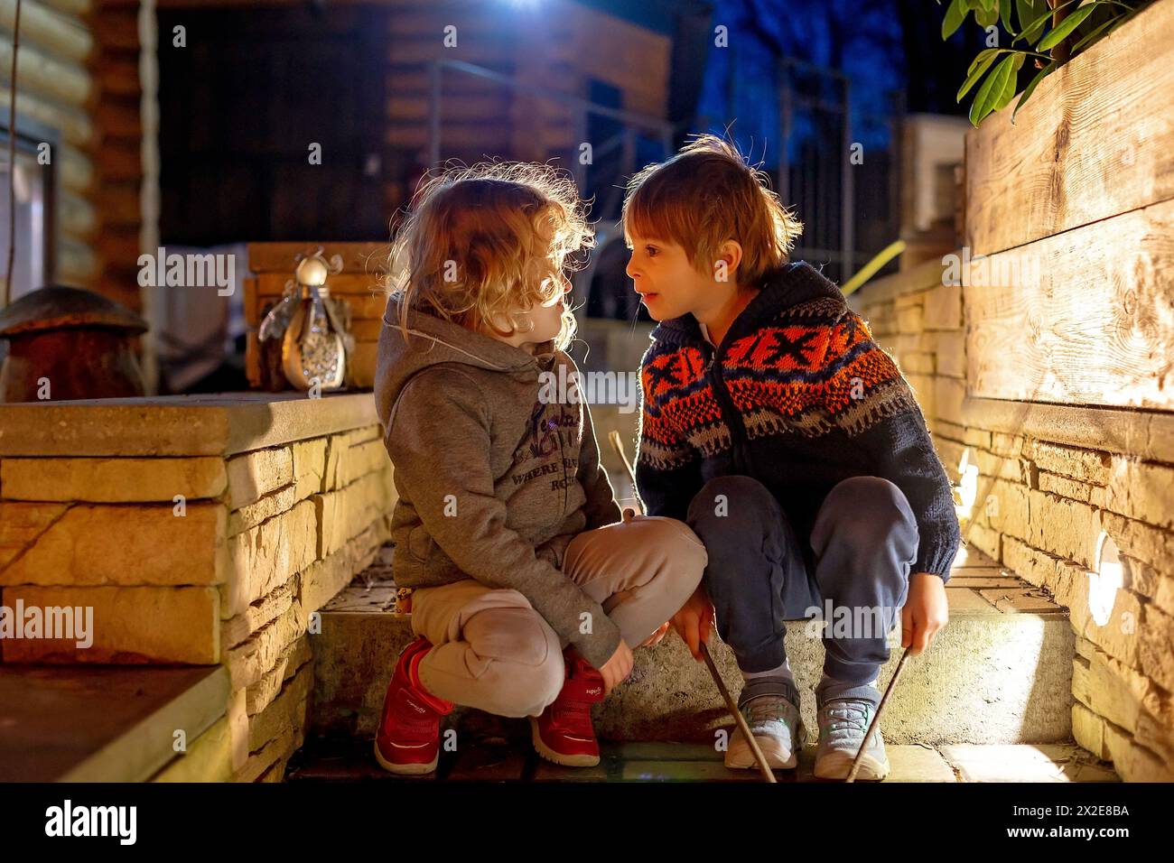 Happy children oudoors at night, having fun laughing and enjoying warm ...