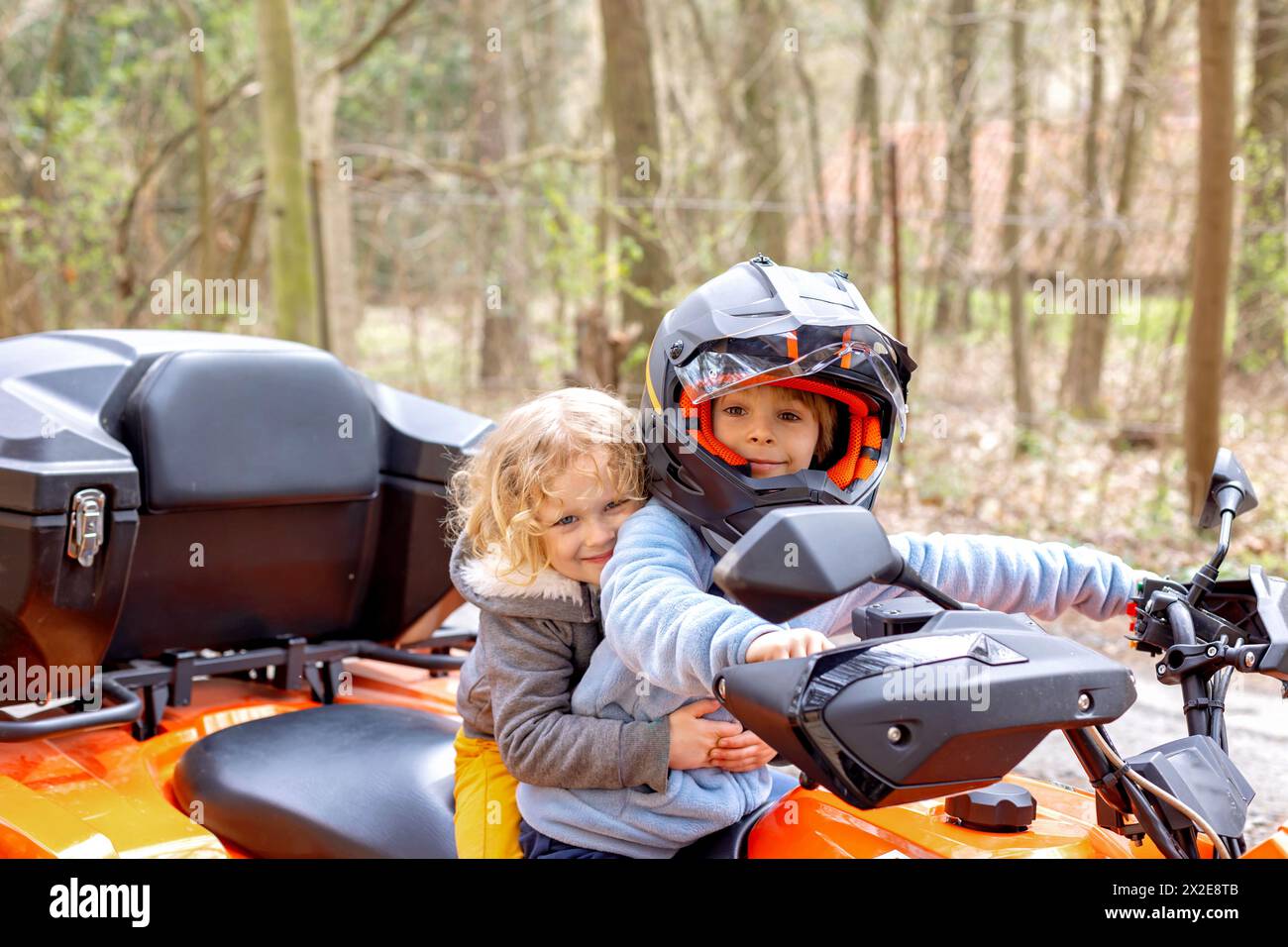 Children, riding on a buggy wheel with father, fast cars, wearing ...