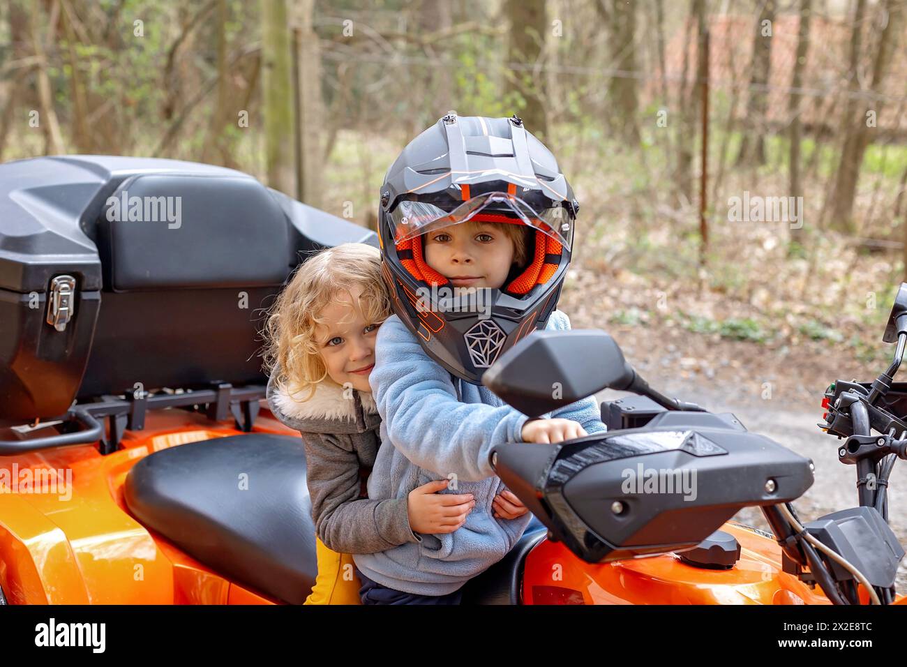 Children, riding on a buggy wheel with father, fast cars, wearing ...