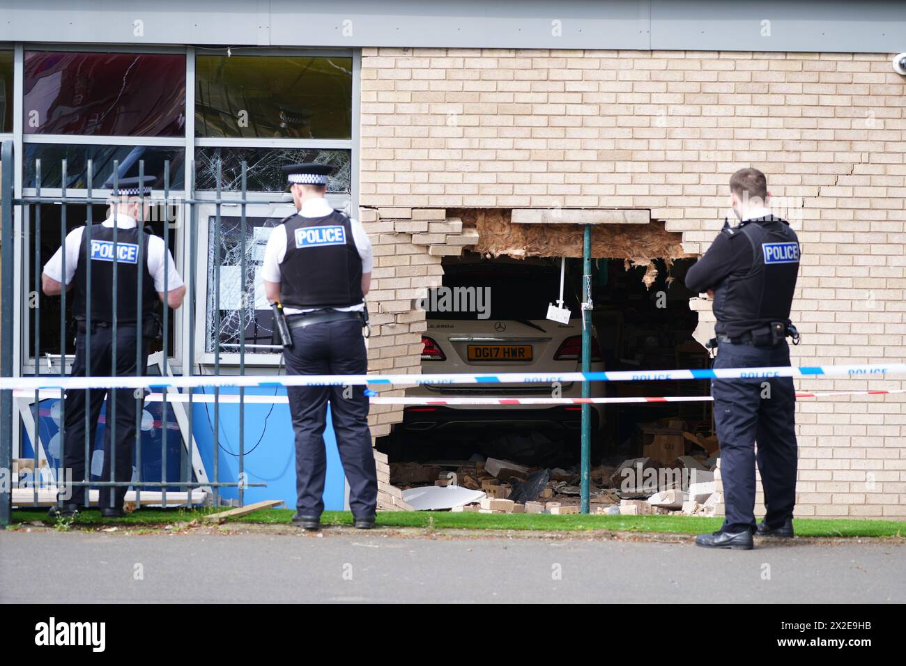 Police officers stand beside the debris and damage to the Beacon Church ...
