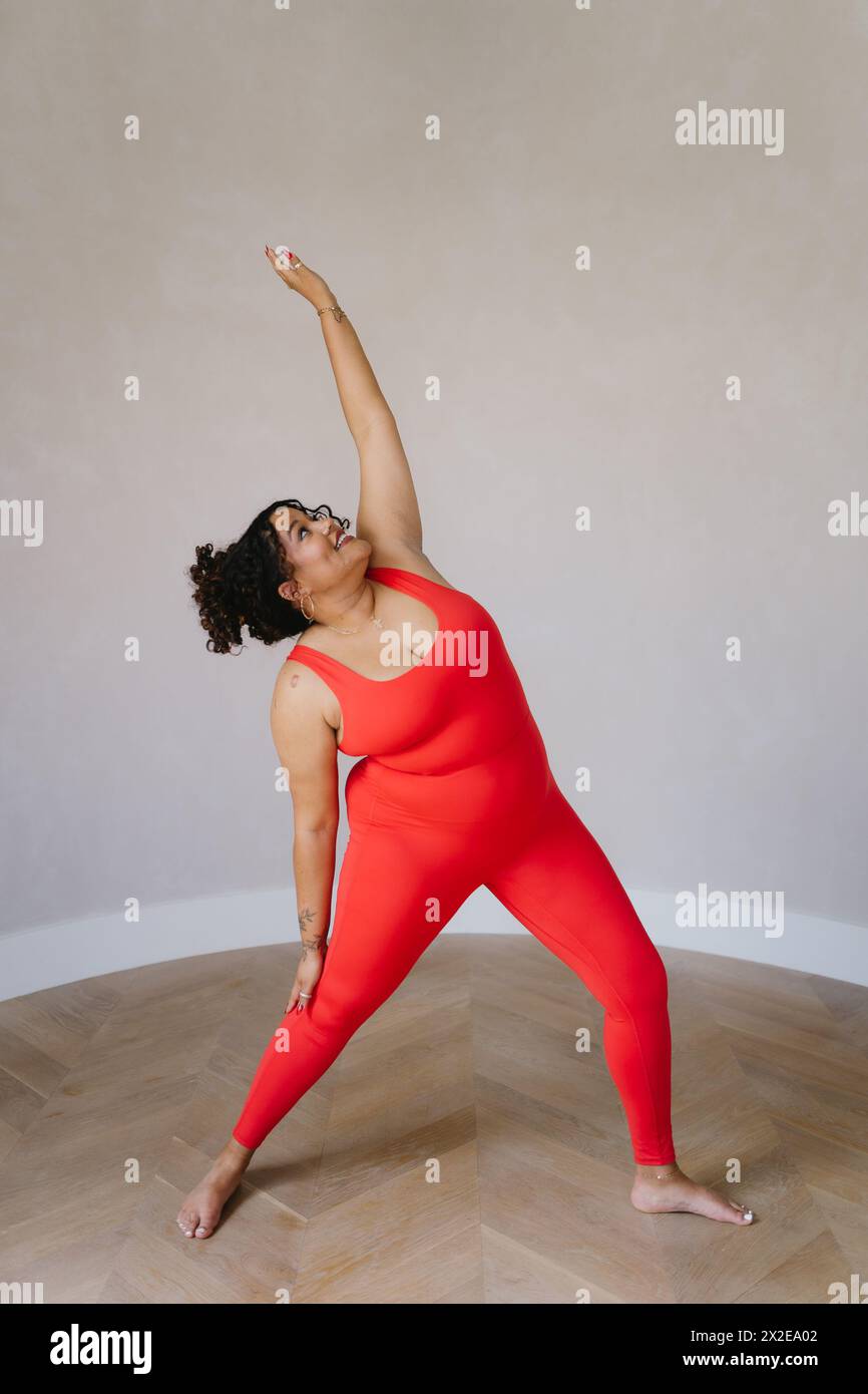 Black woman in yoga studio stretching Stock Photo - Alamy