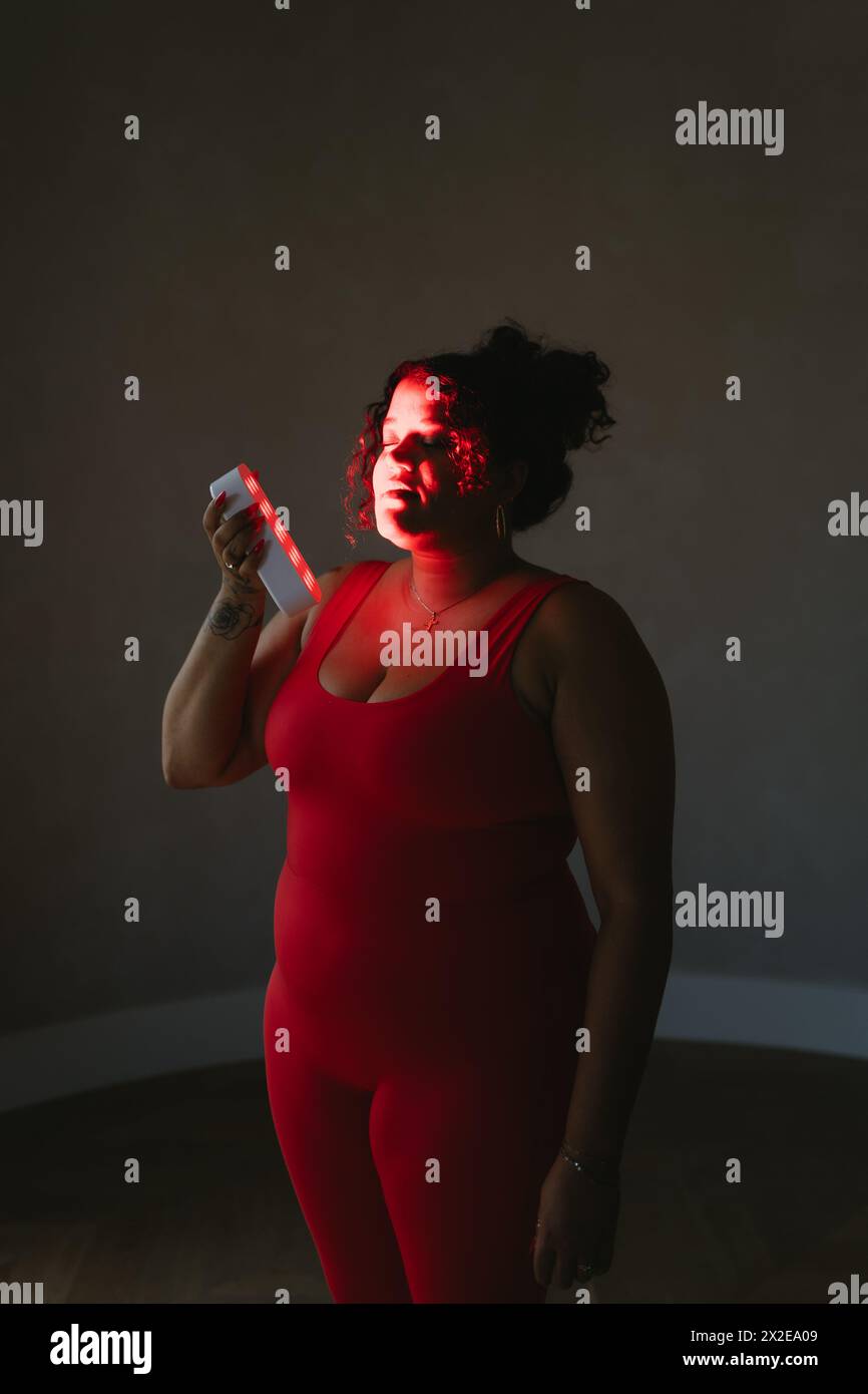 Black woman using infrared red light therapy skincare Stock Photo - Alamy