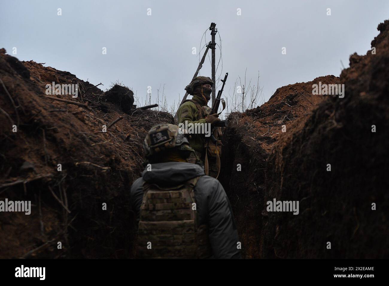 Ukrainian soldiers walk through a trench system, 100 meters away from ...