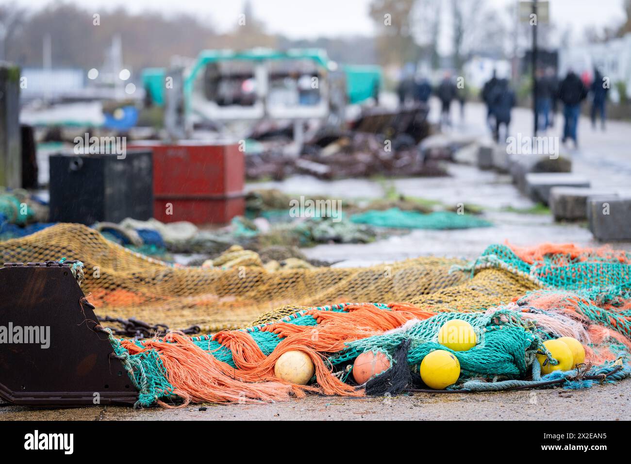 Fishing nets on the harbor quay. Heap of colourful trawling fishing ...