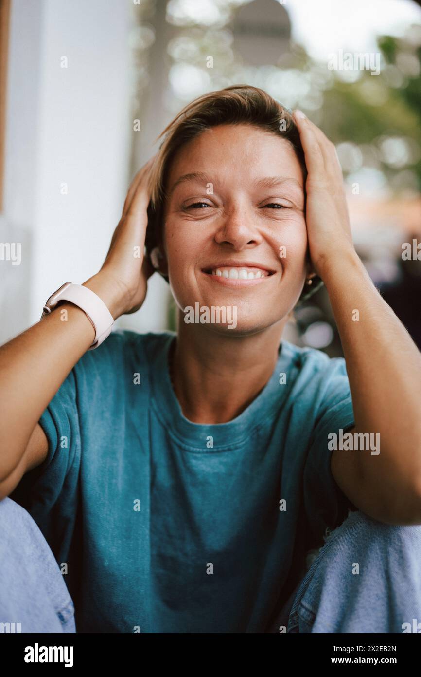 Happy laughing woman pulling her cap over her eyes. Fool Stock Photo ...