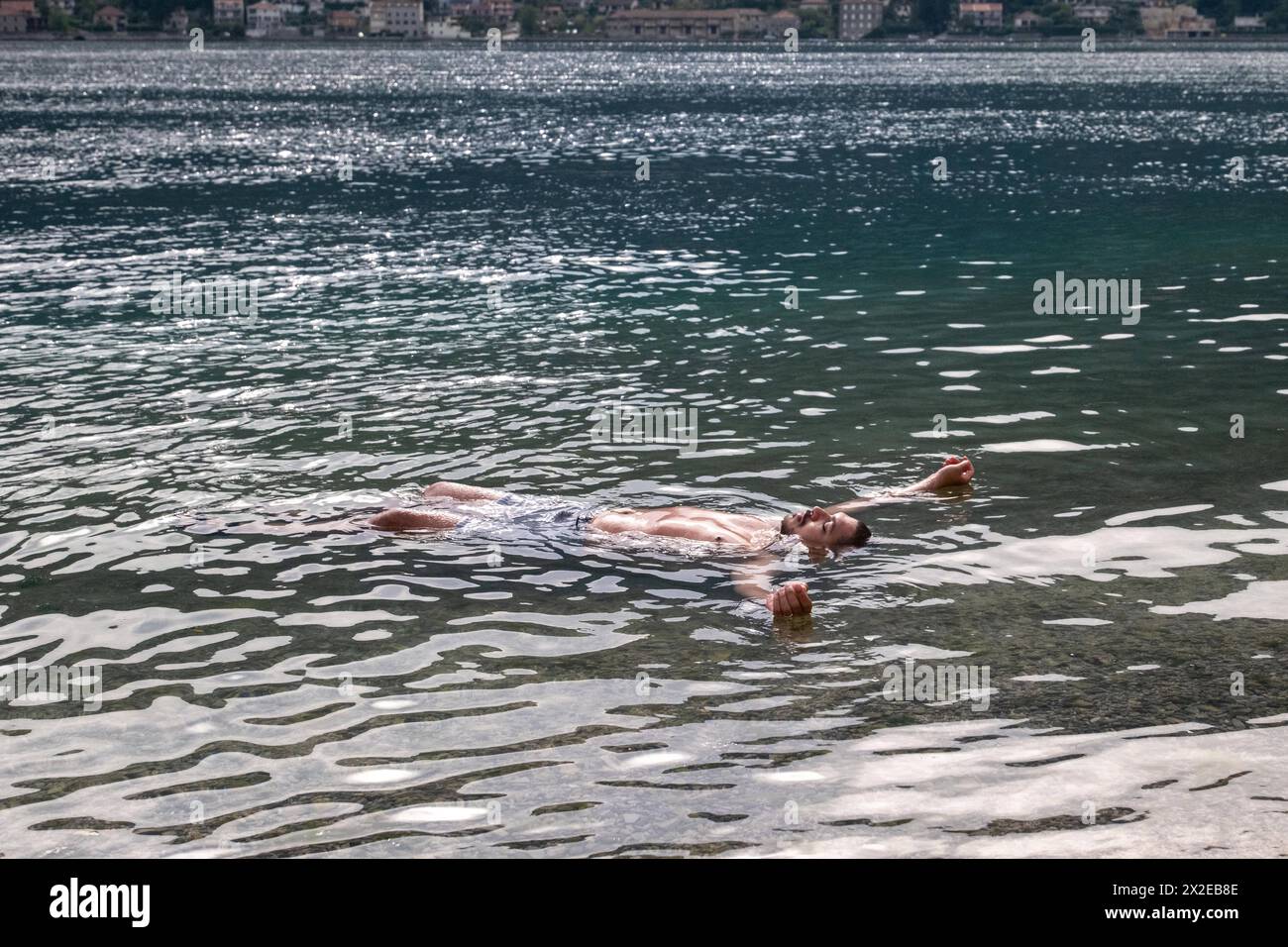 Man floating on Kotor Bay Stock Photo - Alamy