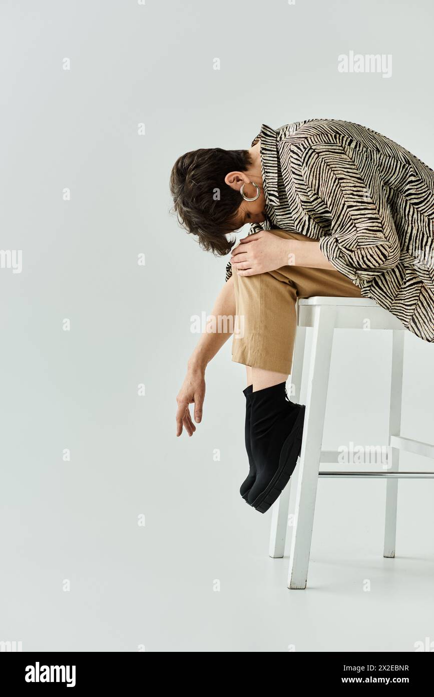 A middle-aged woman in stylish attire sitting gracefully atop a white ...