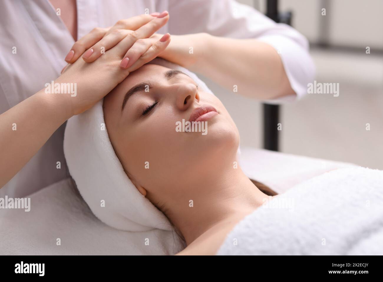 Cosmetologist making face massage to client in clinic, closeup Stock ...