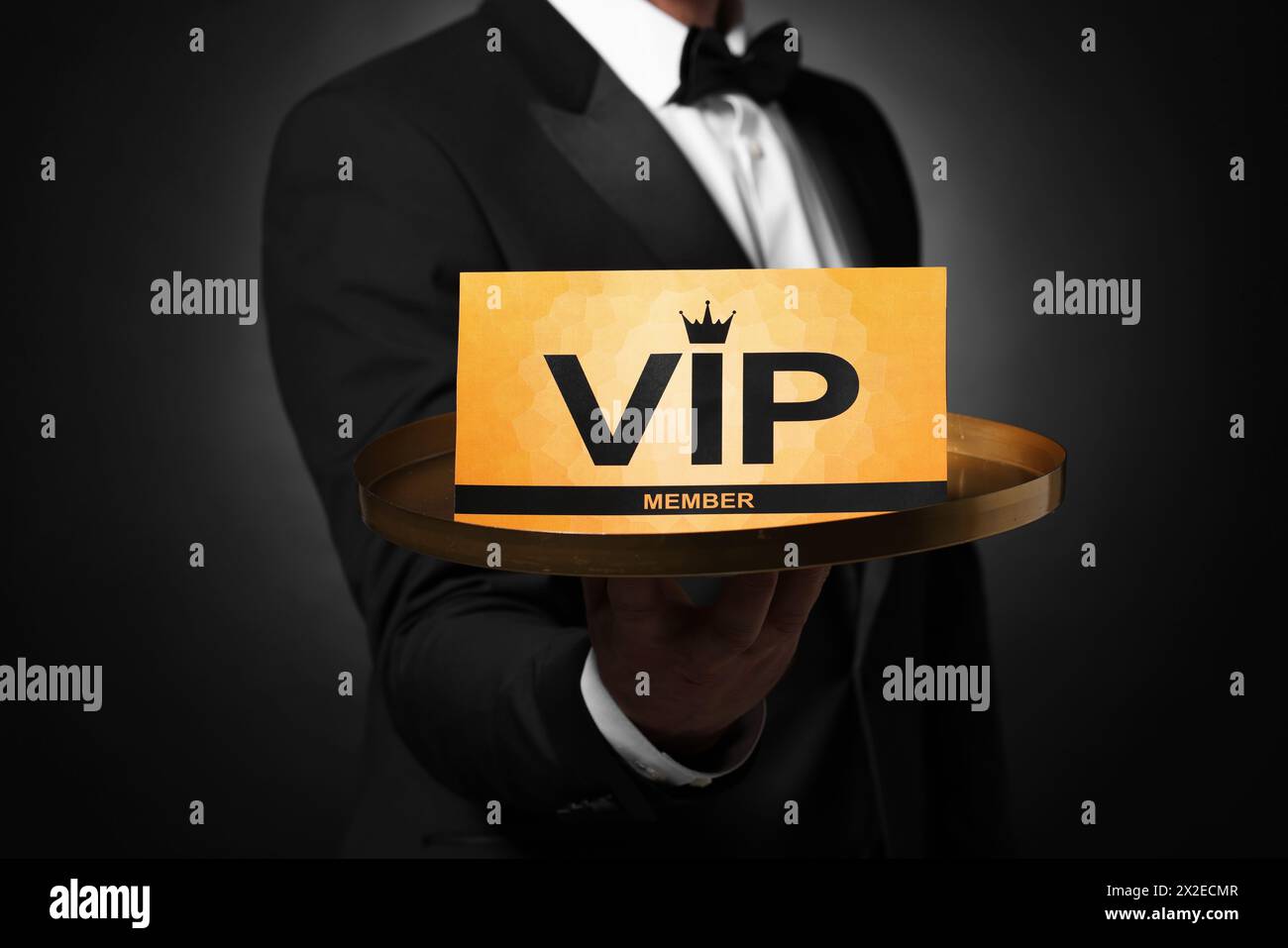 Man holding tray with VIP sign on black background, closeup Stock Photo ...