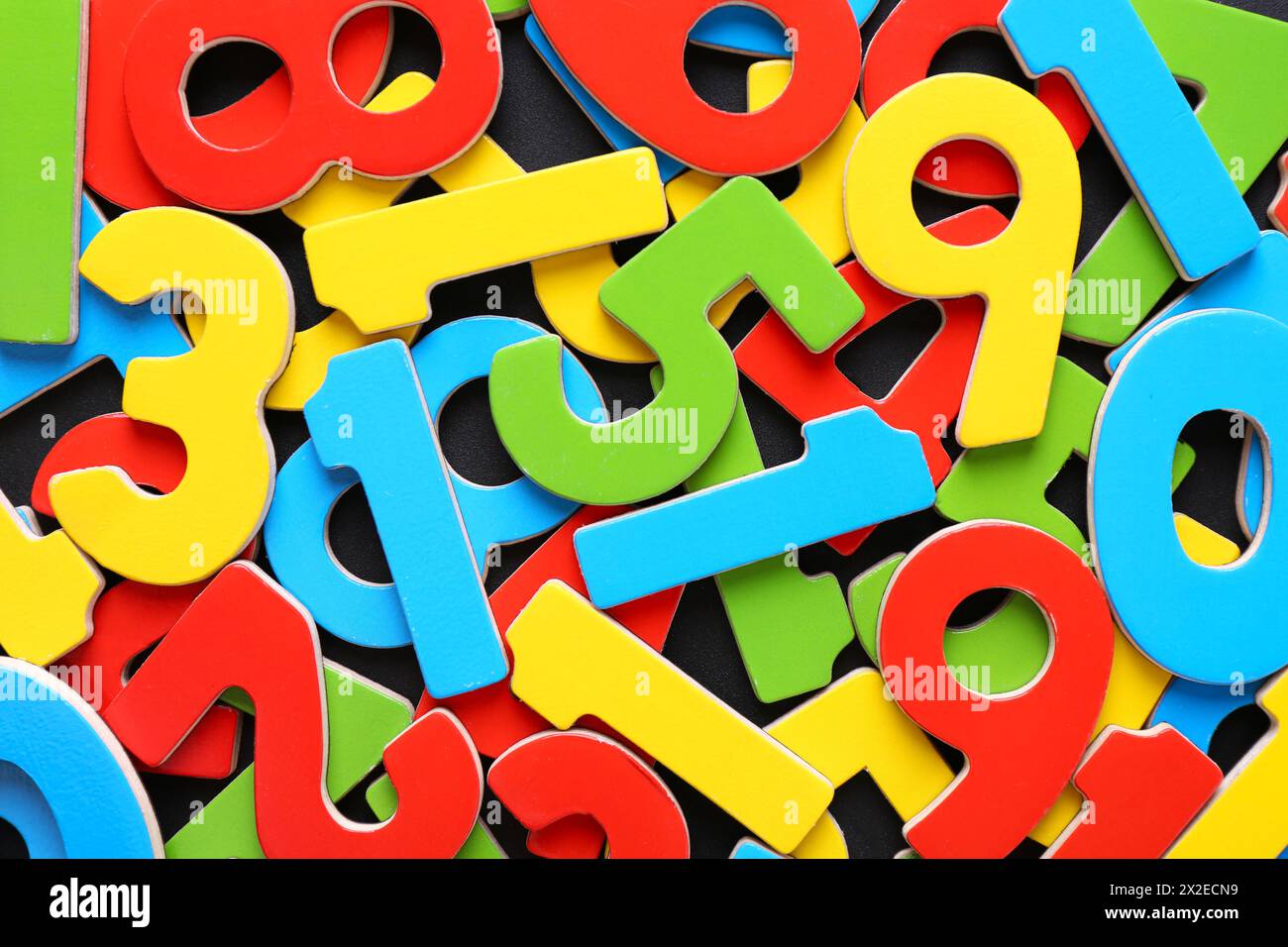 Colorful numbers on black background, top view Stock Photo - Alamy
