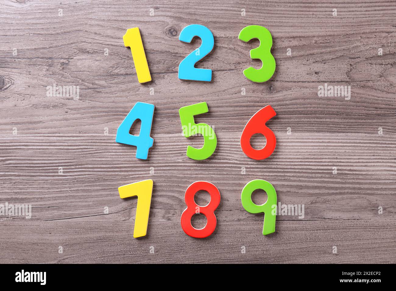 Colorful numbers on wooden school desk, flat lay Stock Photo - Alamy