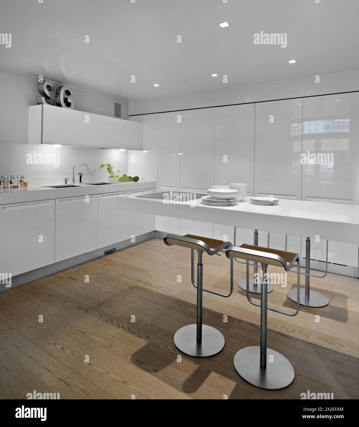 interior shots of a modern white kitchen with table snack and two stool ...