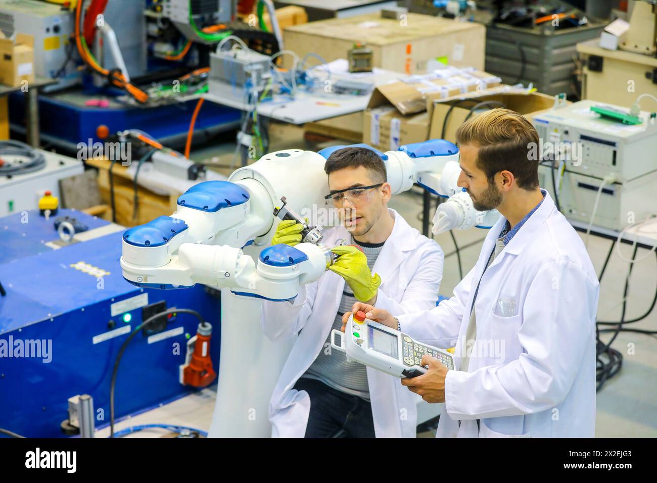 Two-arm robot for industrial handling. Researchers working on robot ...