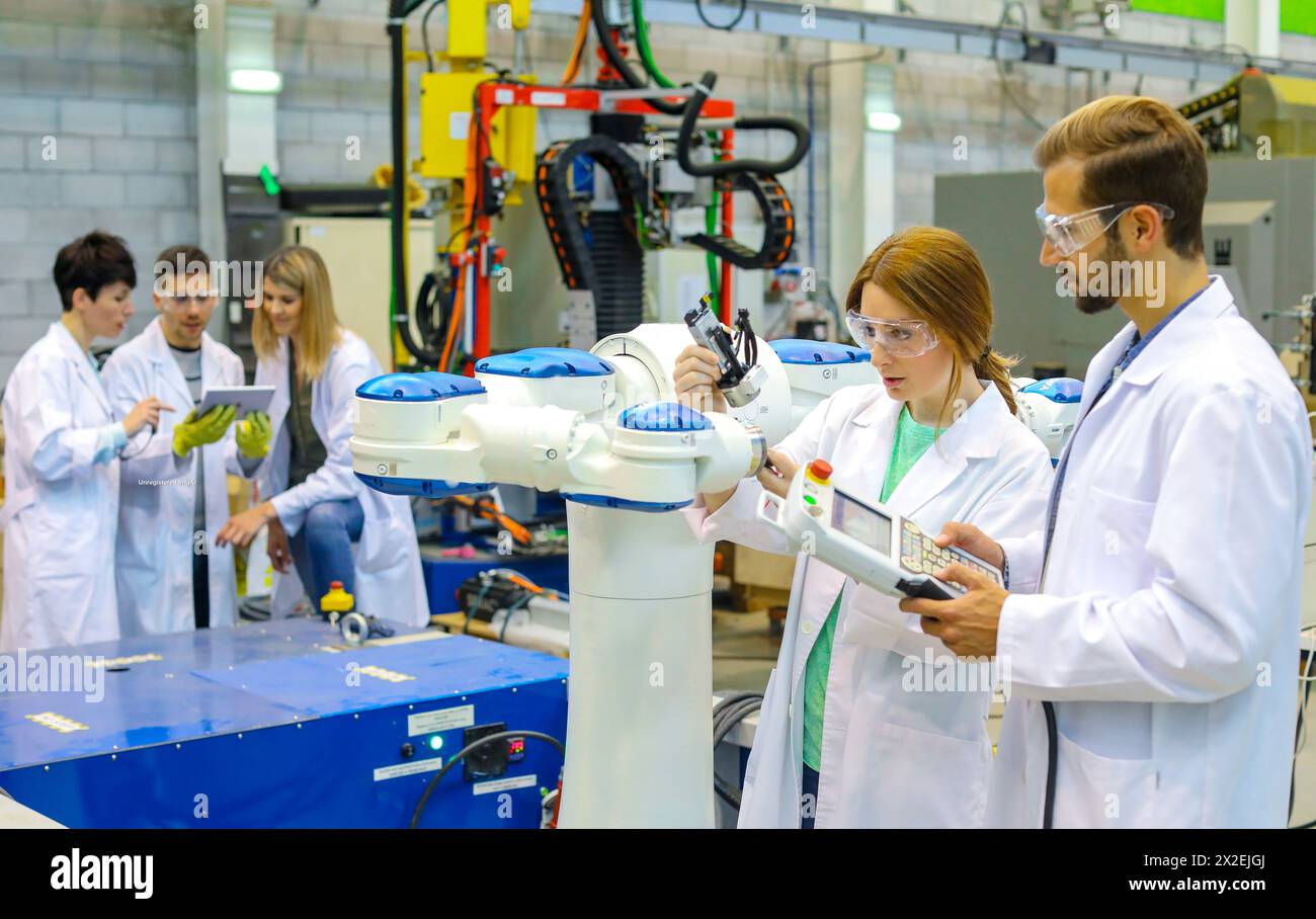 Two-arm robot for industrial handling. Researchers working on robot ...