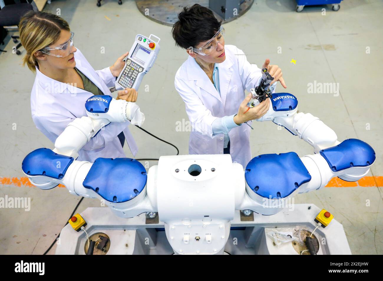 Two-arm robot for industrial handling. Researchers working on robot ...