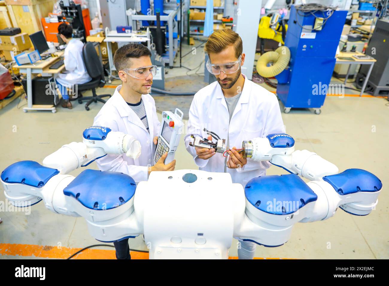 Two-arm robot for industrial handling. Researchers working on robot ...
