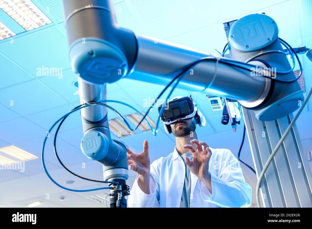 Robotic arm with artificial vision, Researcher with virtual reality glasses, VR, Humanoid robot ...