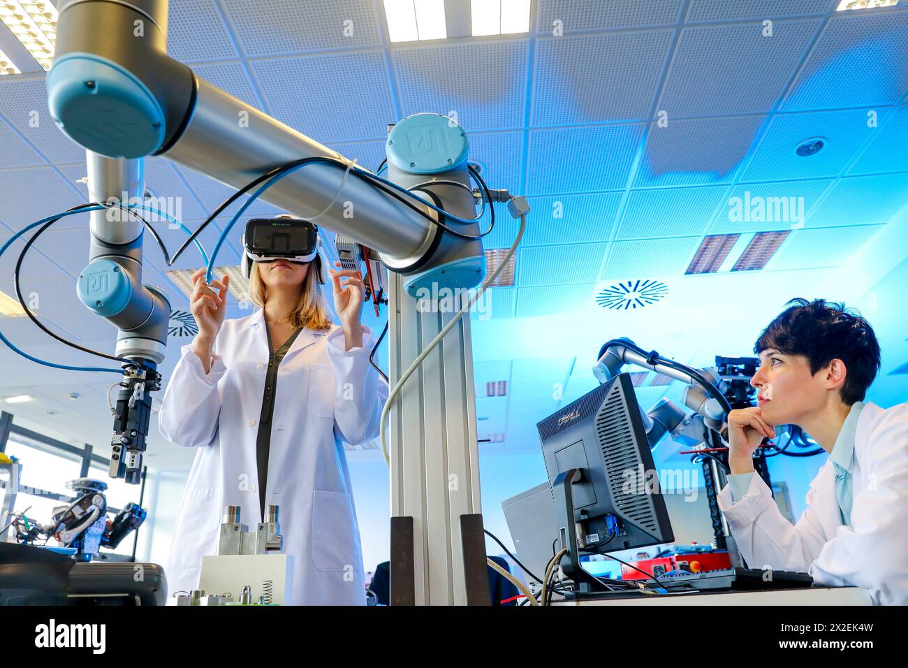 Robotic arm with artificial vision, Researcher with virtual reality glasses, VR, Humanoid robot ...