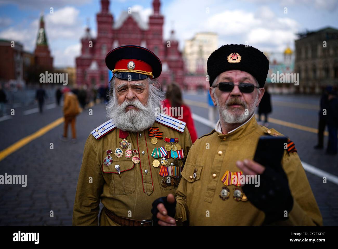 Two men in Russian Cossack uniforms pose for a selfie after visiting ...