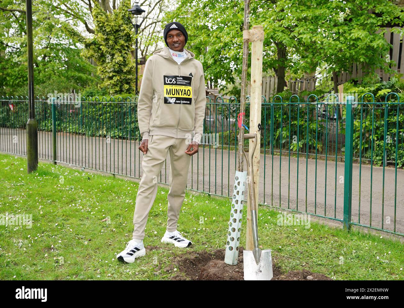 Men's elite race winner Alexander Mutiso Munyao plants a tree as part ...