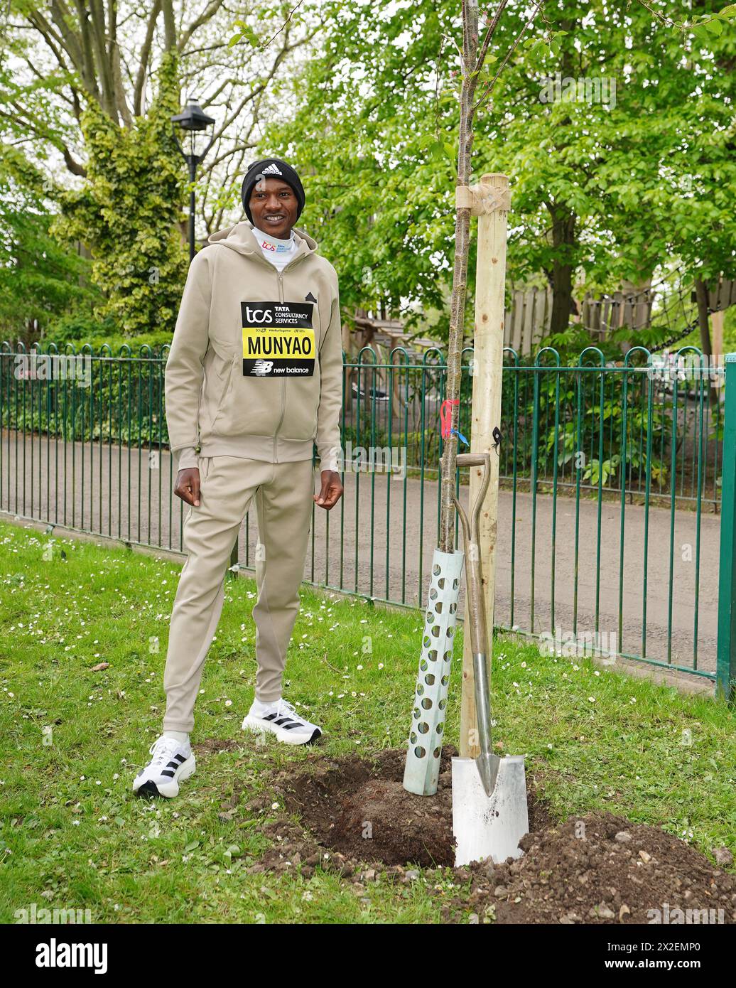 Men's elite race winner Alexander Mutiso Munyao plants a tree as part ...