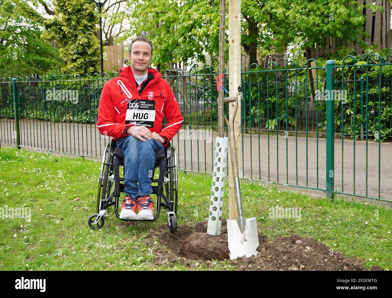 Men's wheelchair race winner Marcel Hug plants a tree as part of the ...