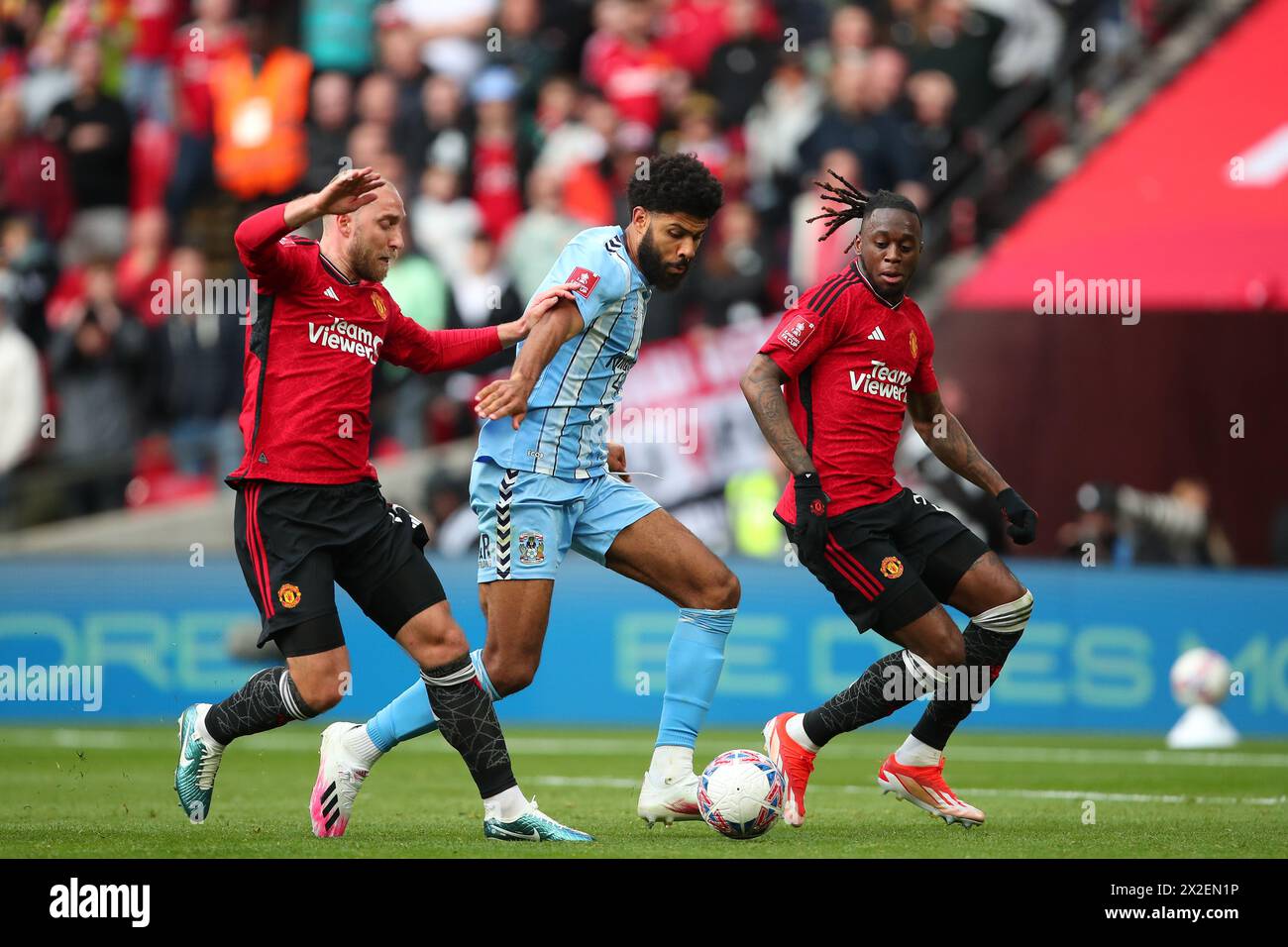 Ellis Simms of Coventry City in action with Christian Eriksen (L) and ...