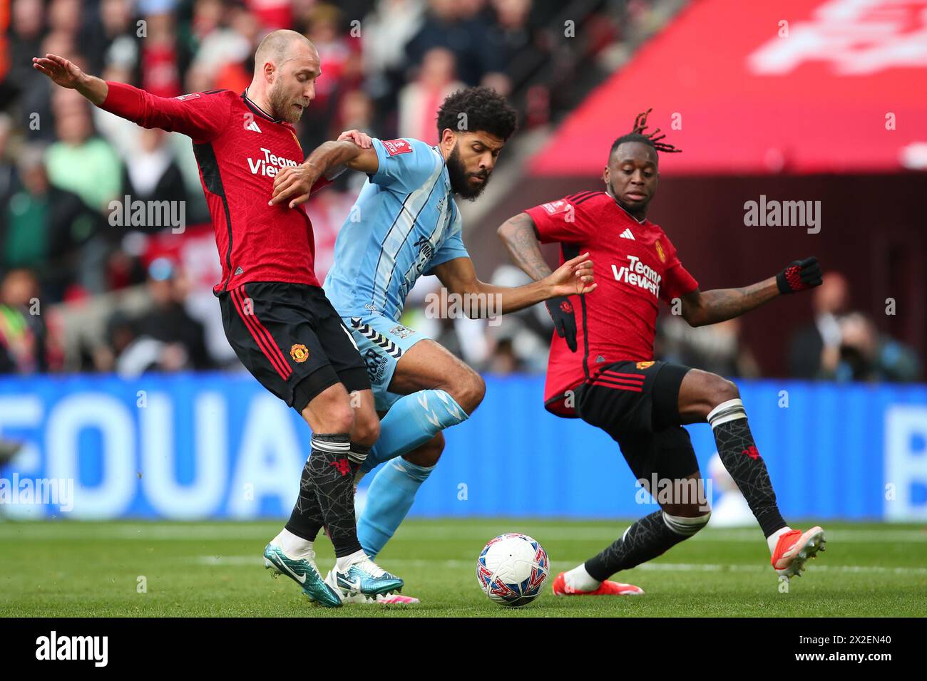 Ellis Simms of Coventry City in action with Christian Eriksen (L) and ...