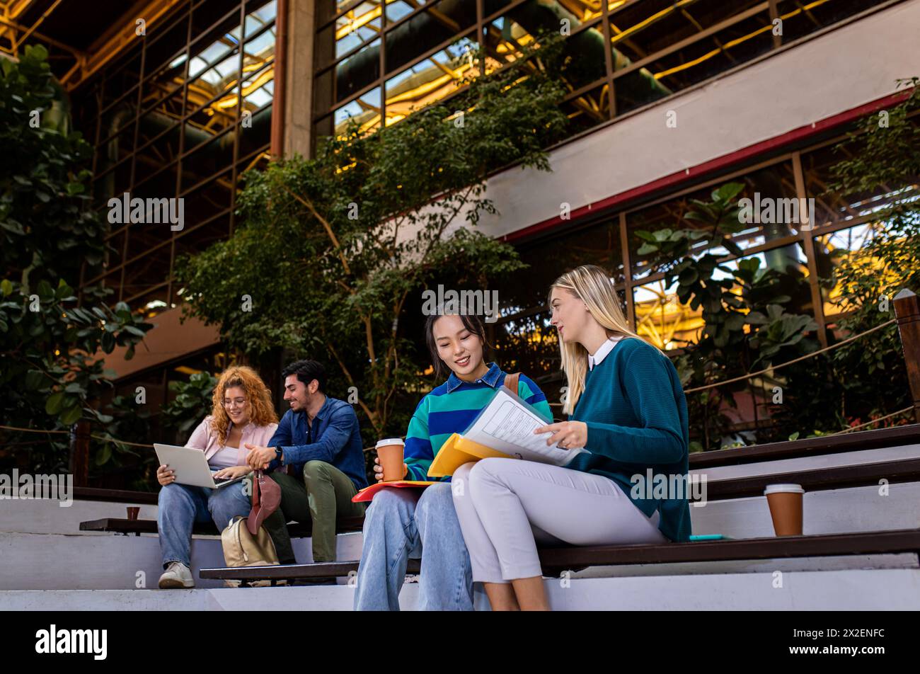 Group of student siting in campus learning together Stock Photo - Alamy